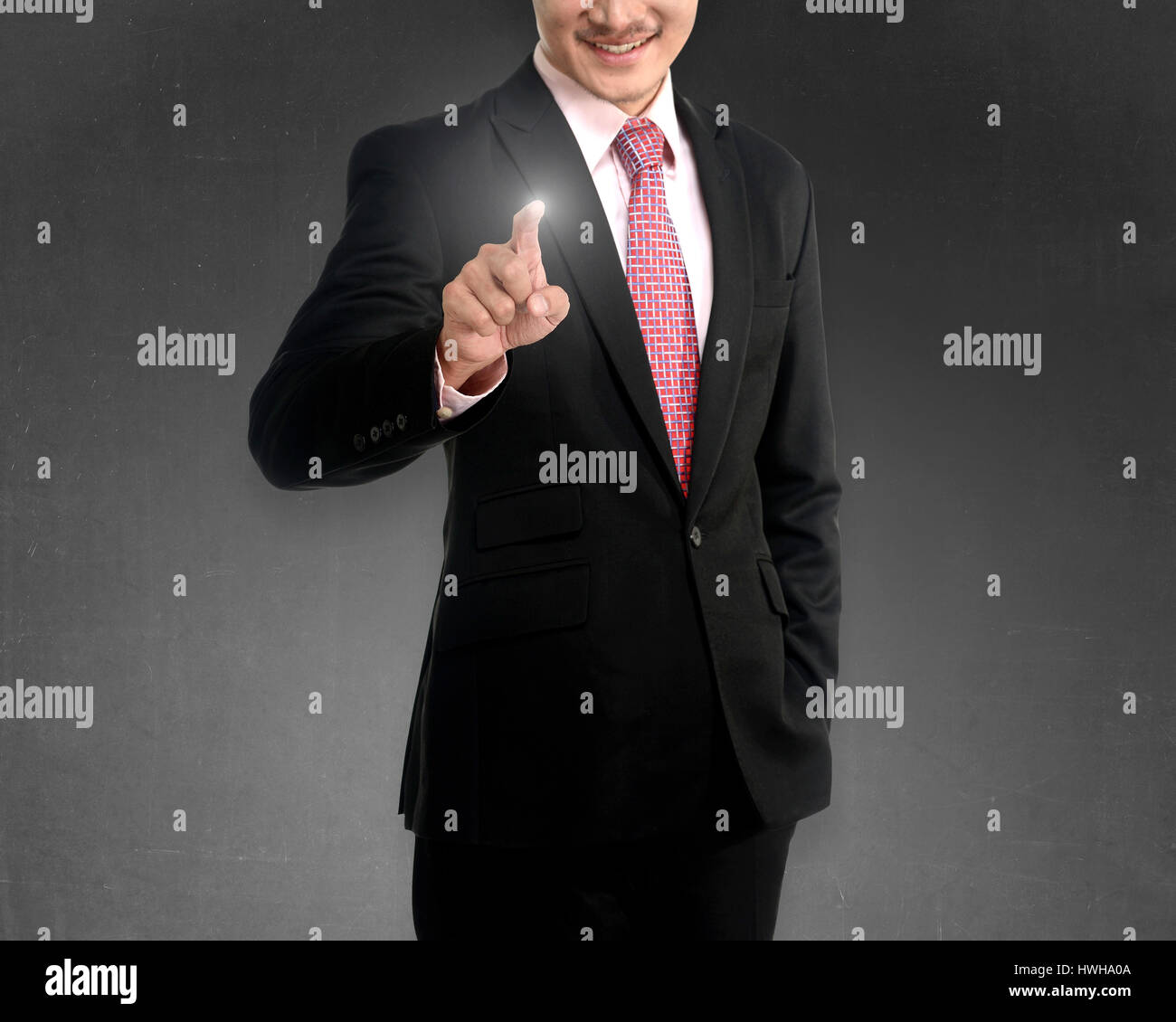 Asian business man write something over grunge wall Stock Photo - Alamy