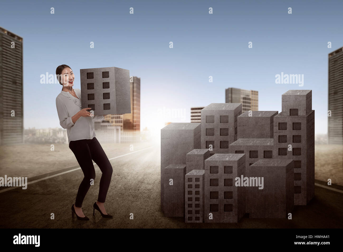 Asian business woman lifting block of city. Building city concept Stock ...