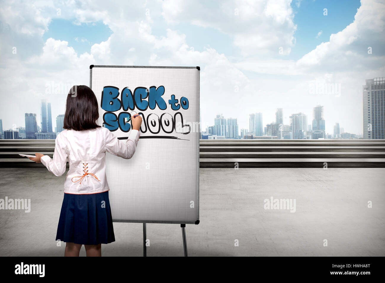 Little girl drawing on canvas back to school writing Stock Photo - Alamy