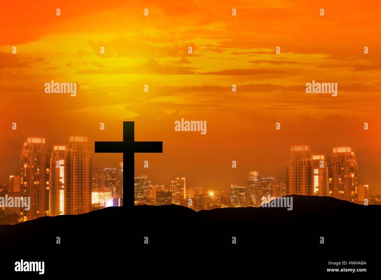 Christian cross with sunset sky and city on the background Stock Photo ...