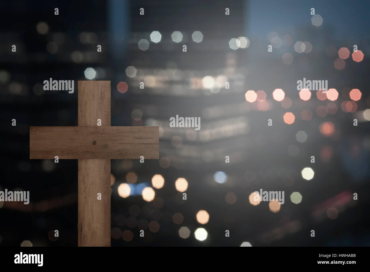 Christian cross with blurry city at night Stock Photo - Alamy