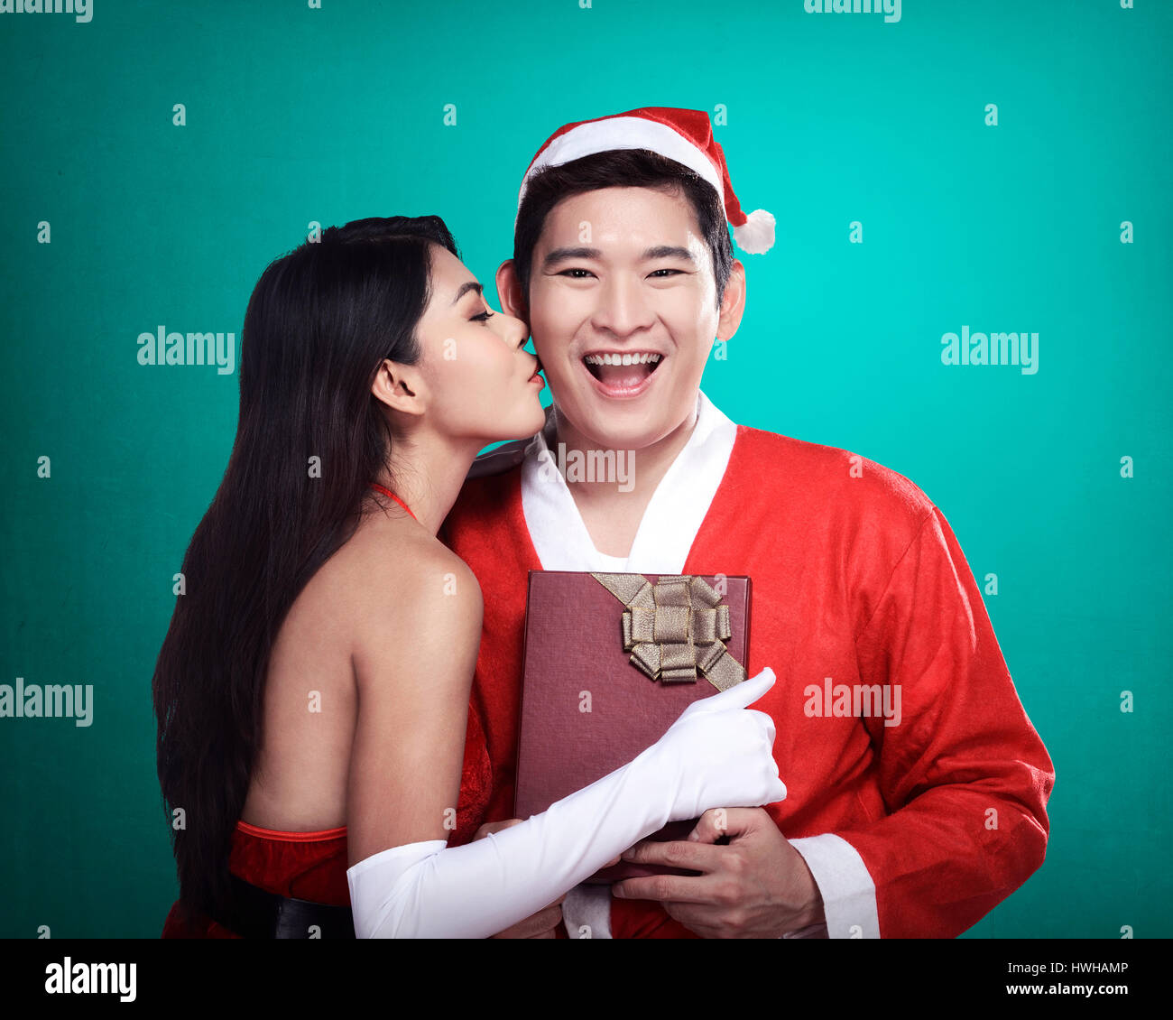 Santa woman give kiss to her lover. Christmas concept Stock Photo - Alamy