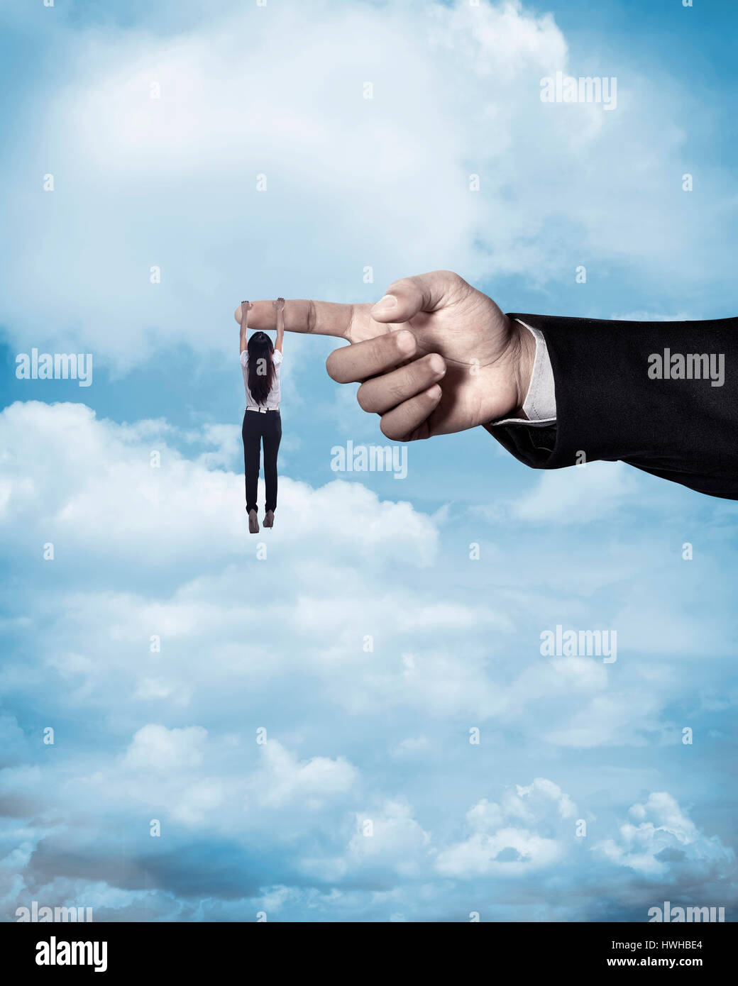 Asian business woman hang on large finger. Help in business concept ...