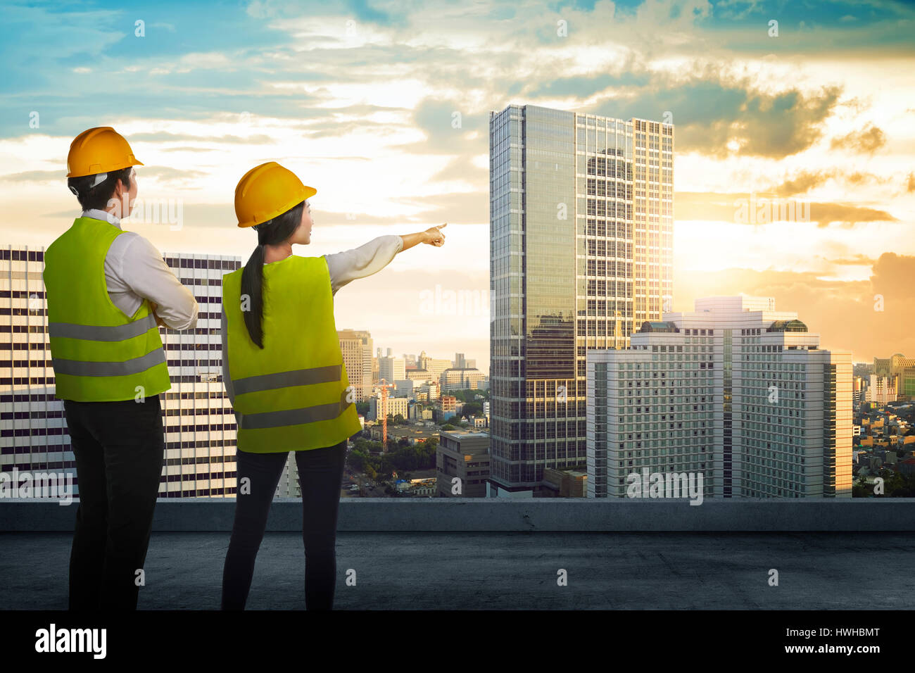 Back view of two architect looking the city from rooftop Stock Photo ...
