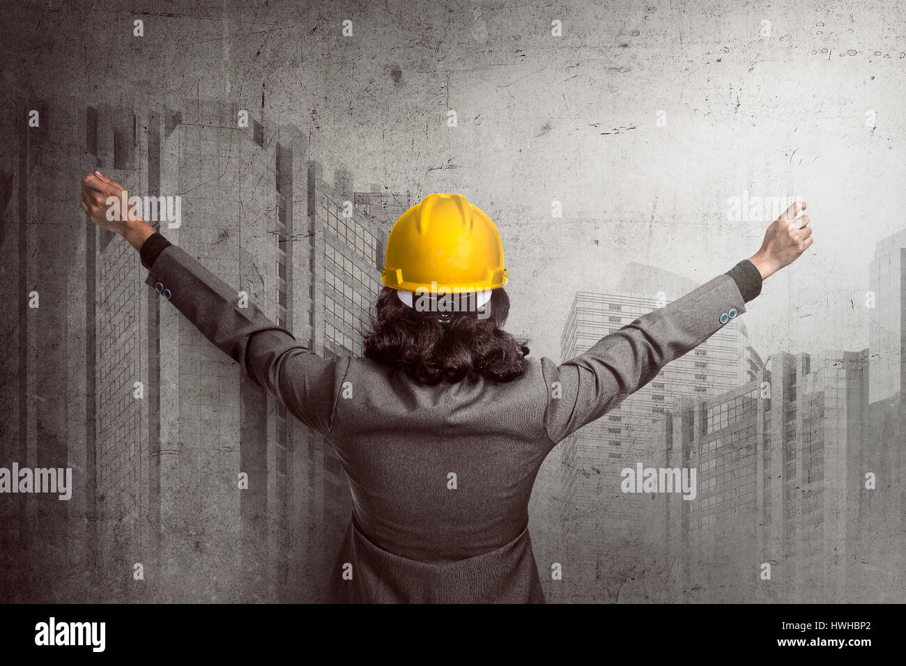 Back view architect raise hand looking at the city Stock Photo - Alamy