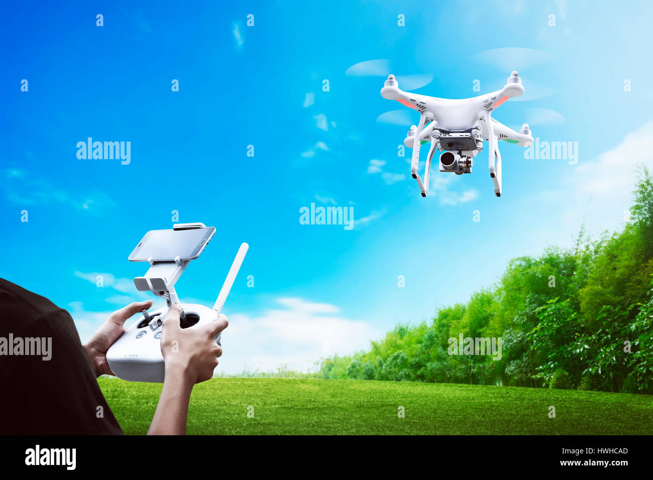 Male pilot controlling drone with remote control Stock Photo - Alamy