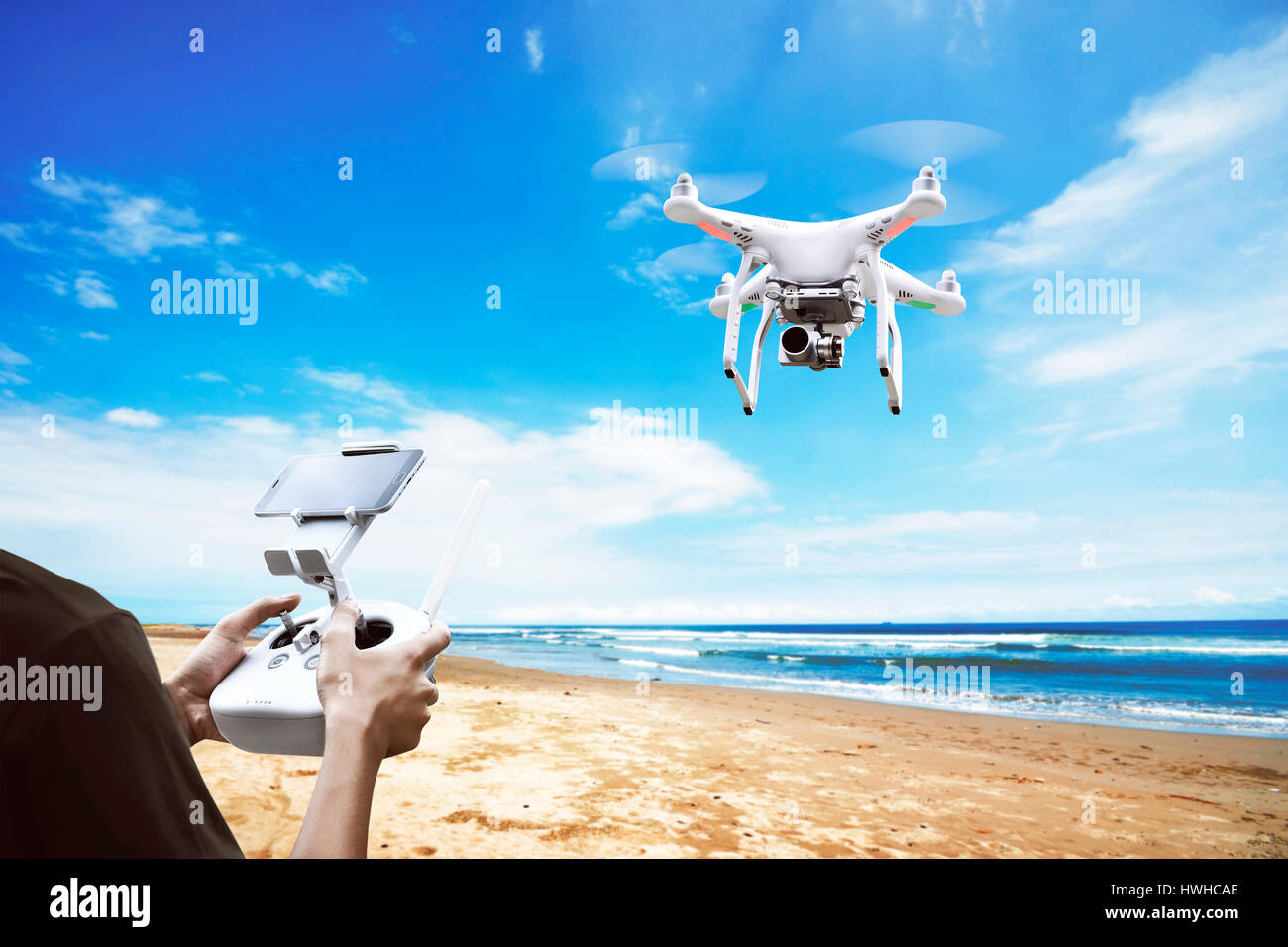 Male pilot controlling drone with remote control Stock Photo - Alamy