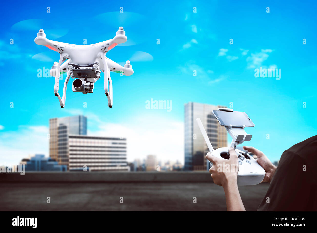 Male pilot controlling drone with remote control Stock Photo - Alamy