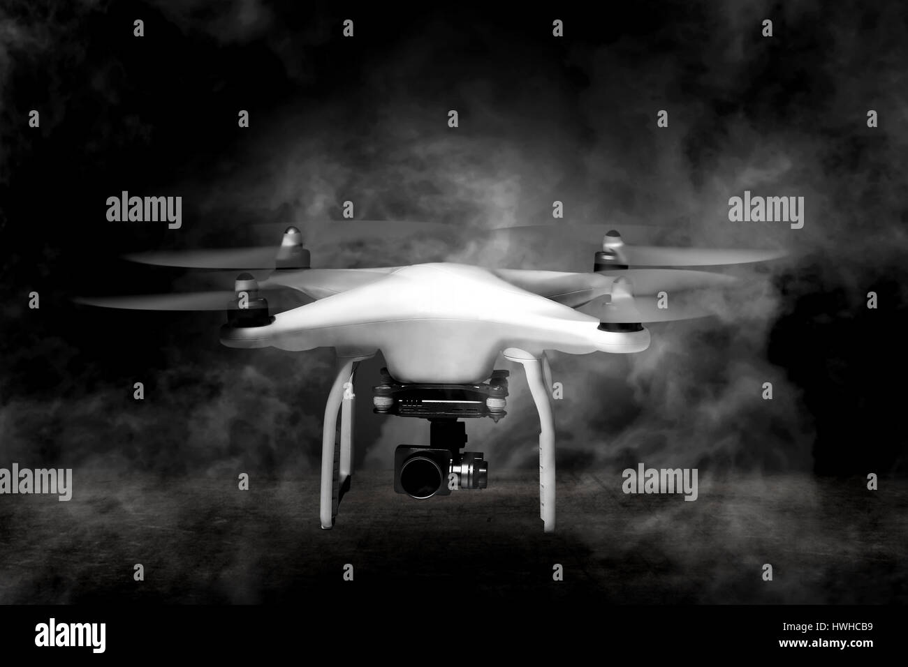 Small white drone with smoke around ready to take off Stock Photo - Alamy