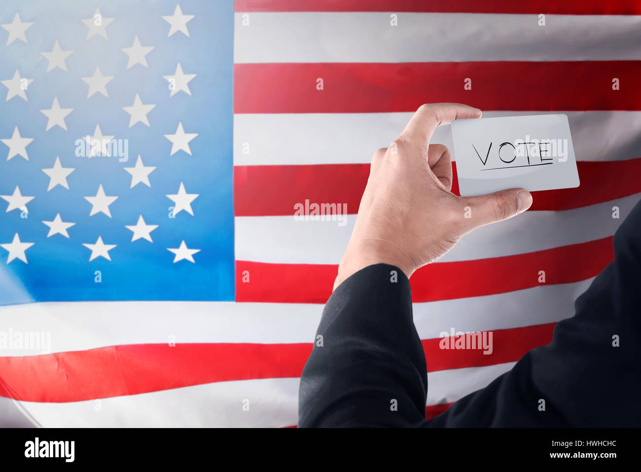 Businessman holding paper with 'VOTE' writing. Election day background ...