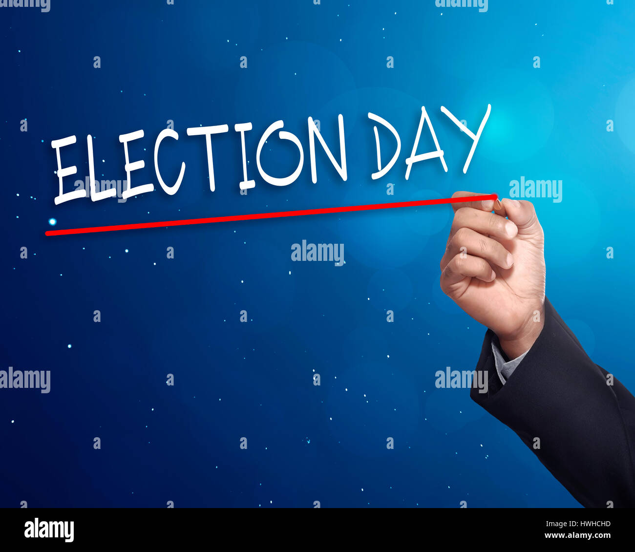 Man hand writing a 'ELECTION DAY' with gold marker on visual screen ...