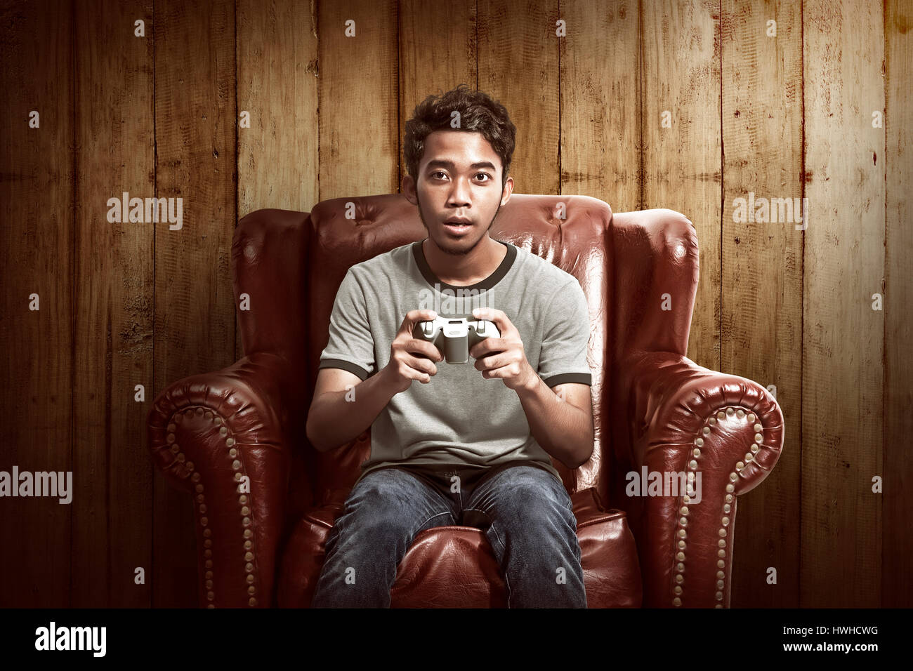 Portrait of asian man playing video games in his living room Stock ...