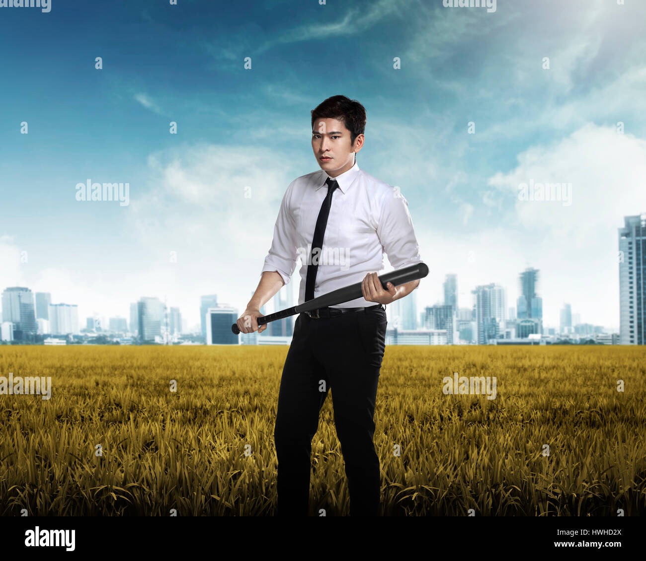 Asian man in white shirt and tie holding baseball bat Stock Photo - Alamy