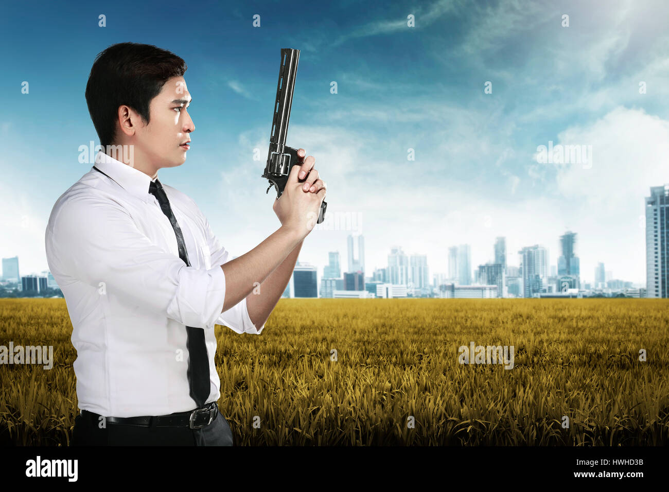 Secret agent holding gun ready to fire Stock Photo - Alamy