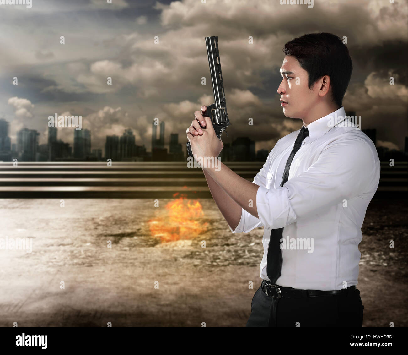 Secret agent holding gun ready to fire Stock Photo - Alamy