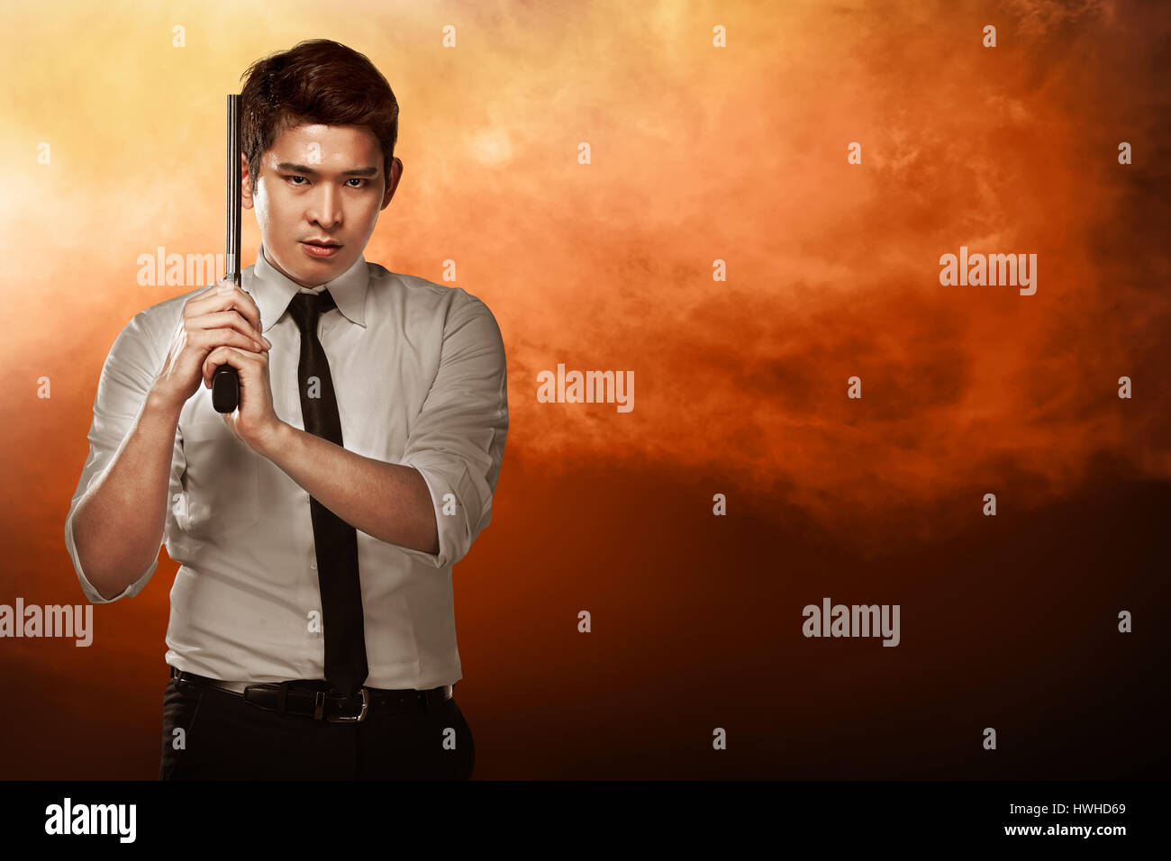 Secret agent holding gun ready to fire Stock Photo - Alamy