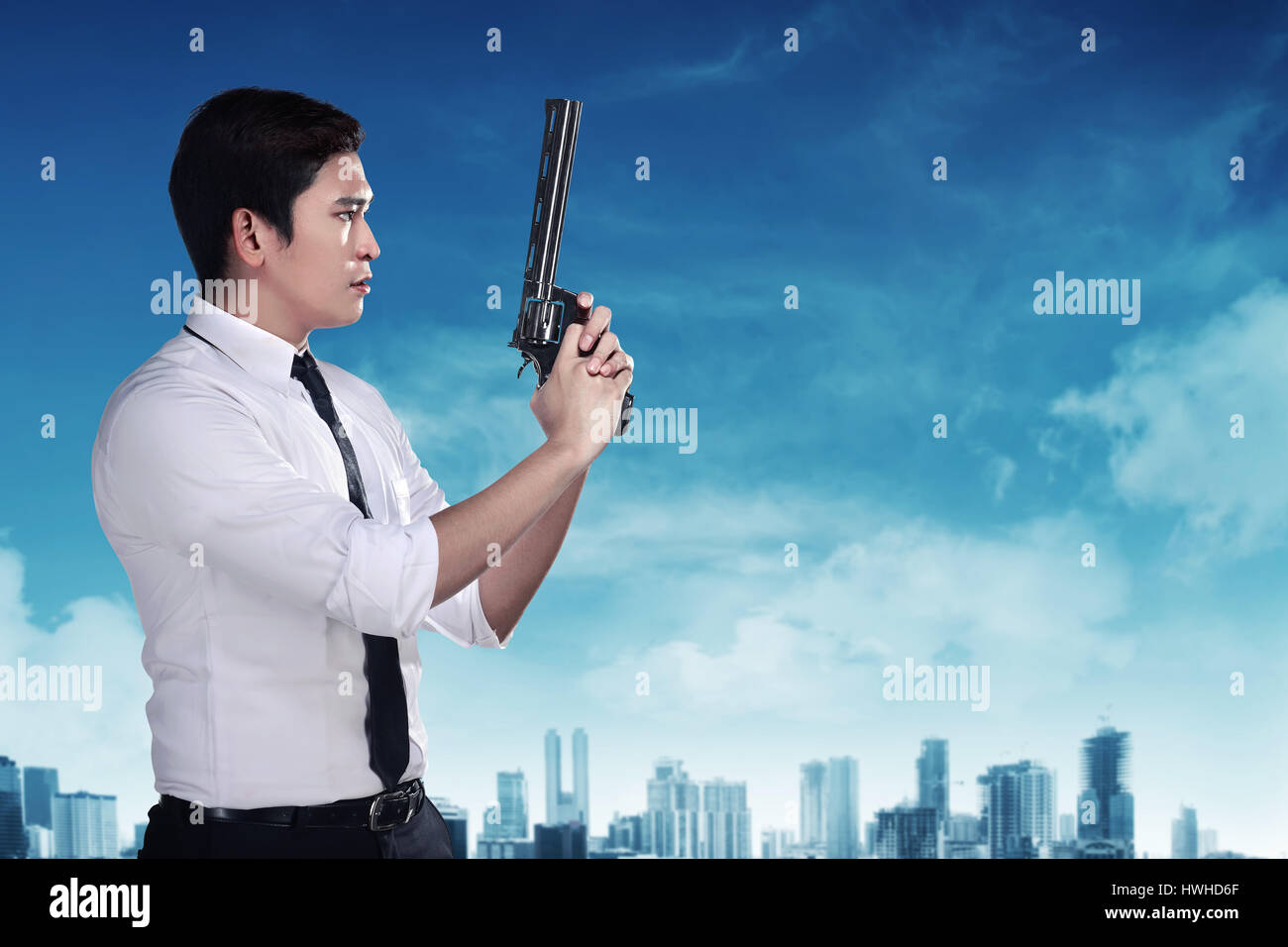 Secret agent holding gun ready to fire Stock Photo - Alamy