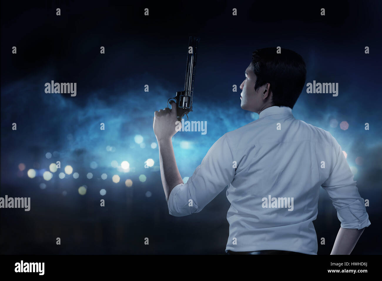 Secret agent holding gun ready to fire Stock Photo - Alamy