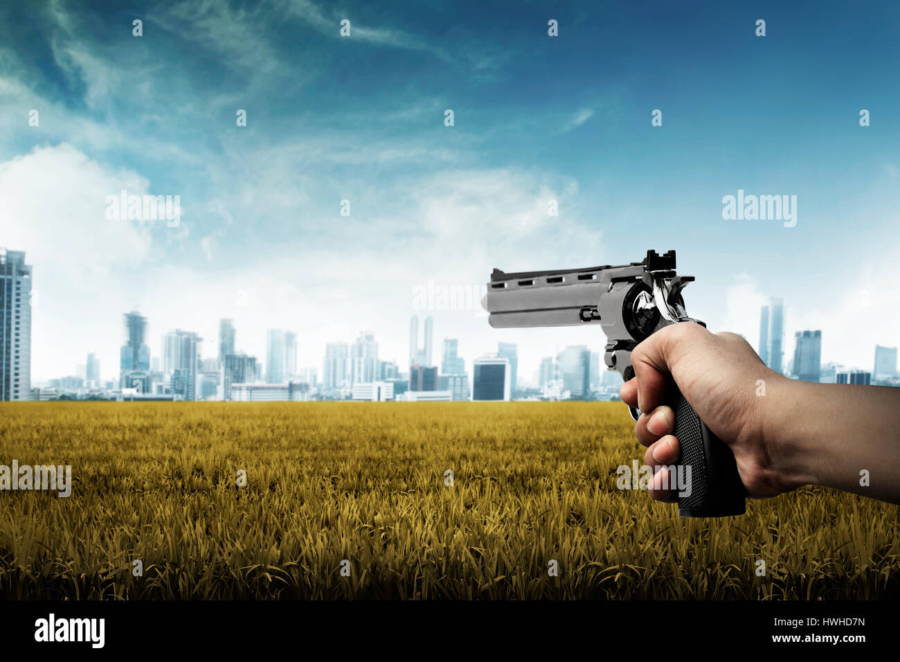Man hand holding gun, aim to the city Stock Photo - Alamy