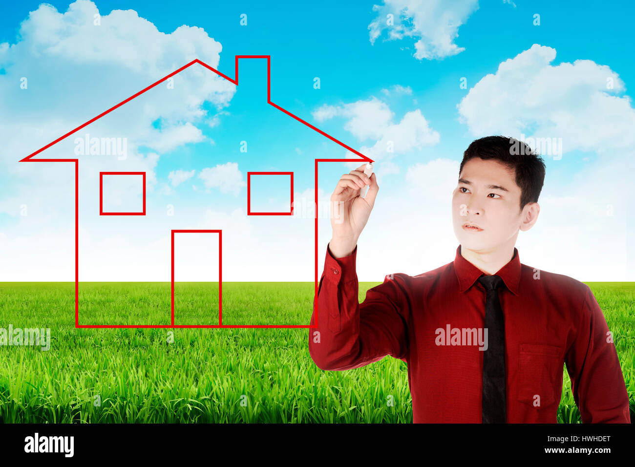 Business man drawing house on the meadow with blue sky background Stock ...