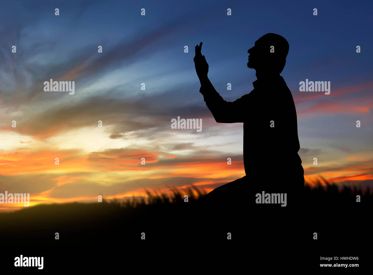 Image of silhouette man praying with sunset background Stock Photo - Alamy