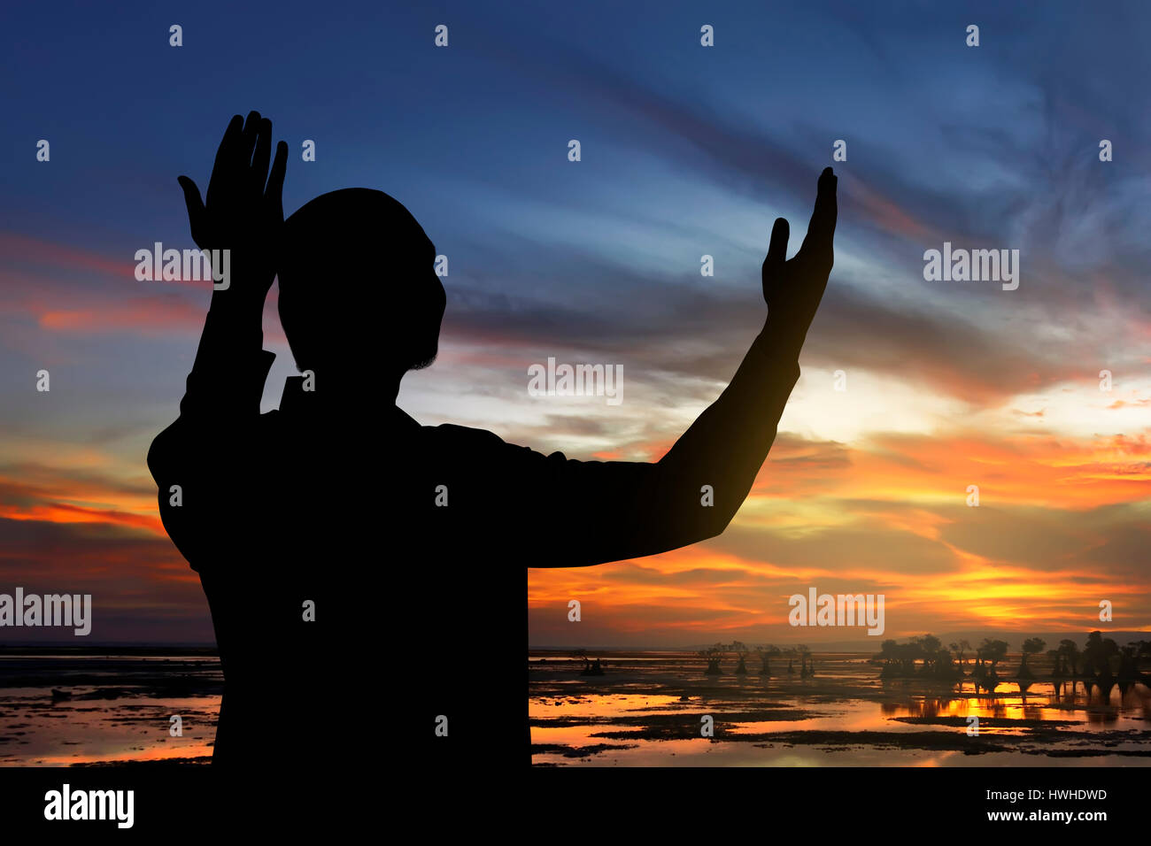Image of silhouette man praying with sunset background Stock Photo - Alamy