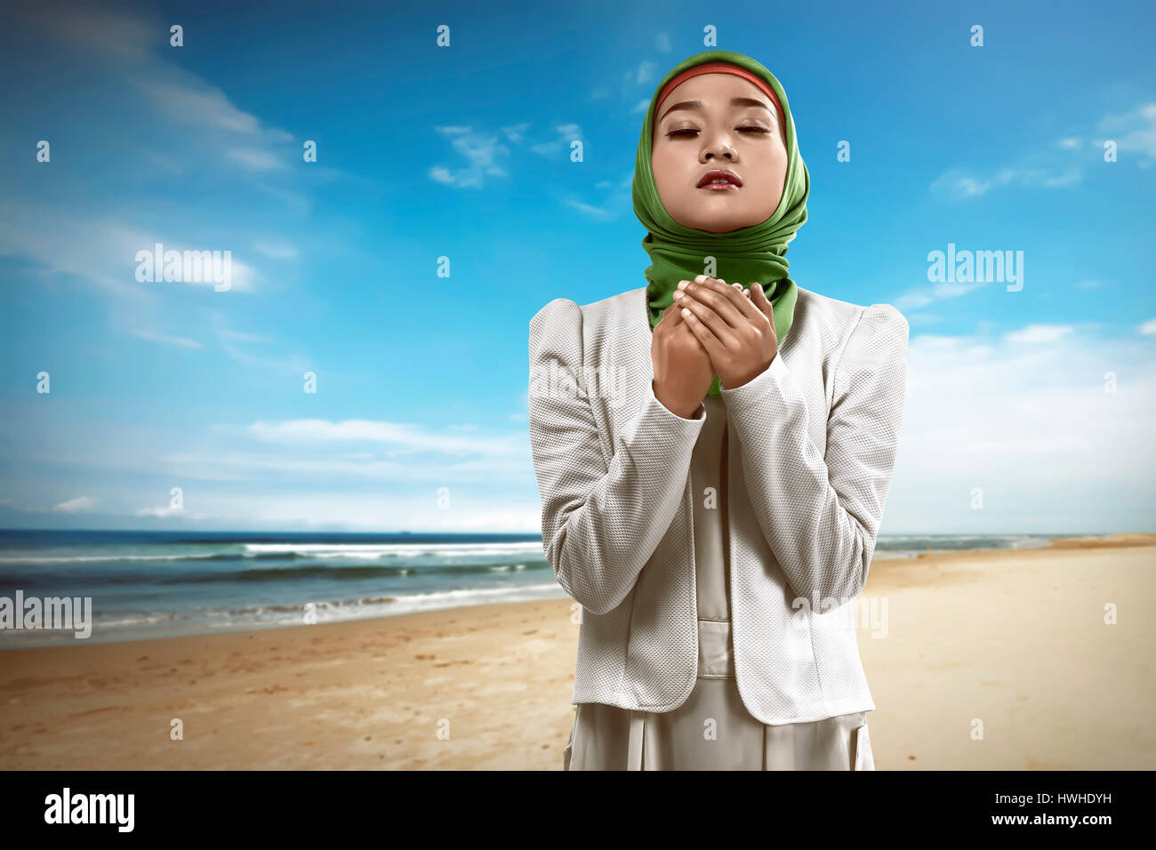 Image of muslim woman praying over beach background Stock Photo - Alamy