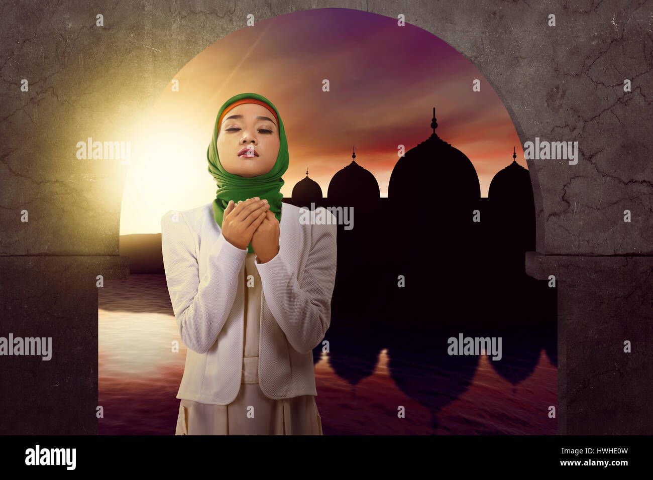 Asian muslim woman pray to god. she wearing hijab inn mosque. she very ...
