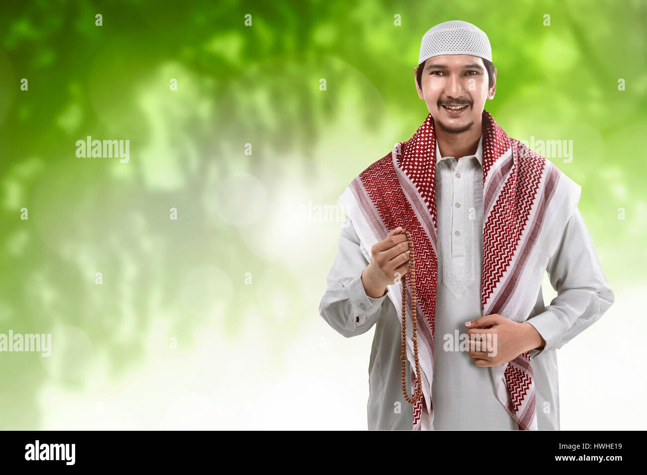 Young asian muslim man, wearing cap smile and look handsome Stock Photo ...