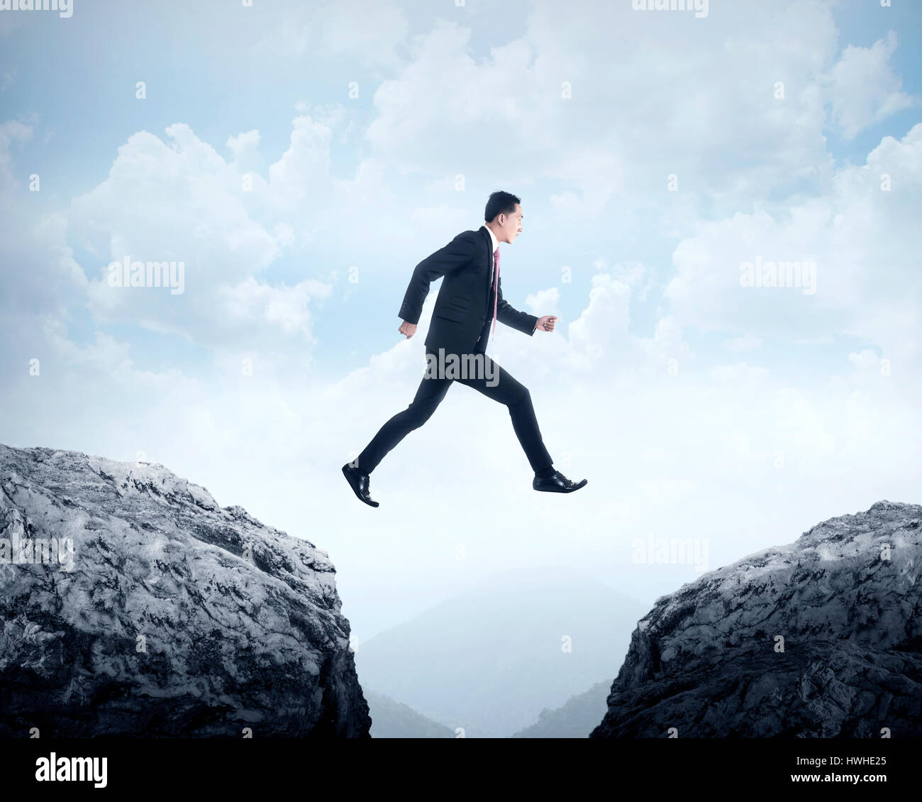 Business man jumping across hill. Business challenge conceptual Stock ...