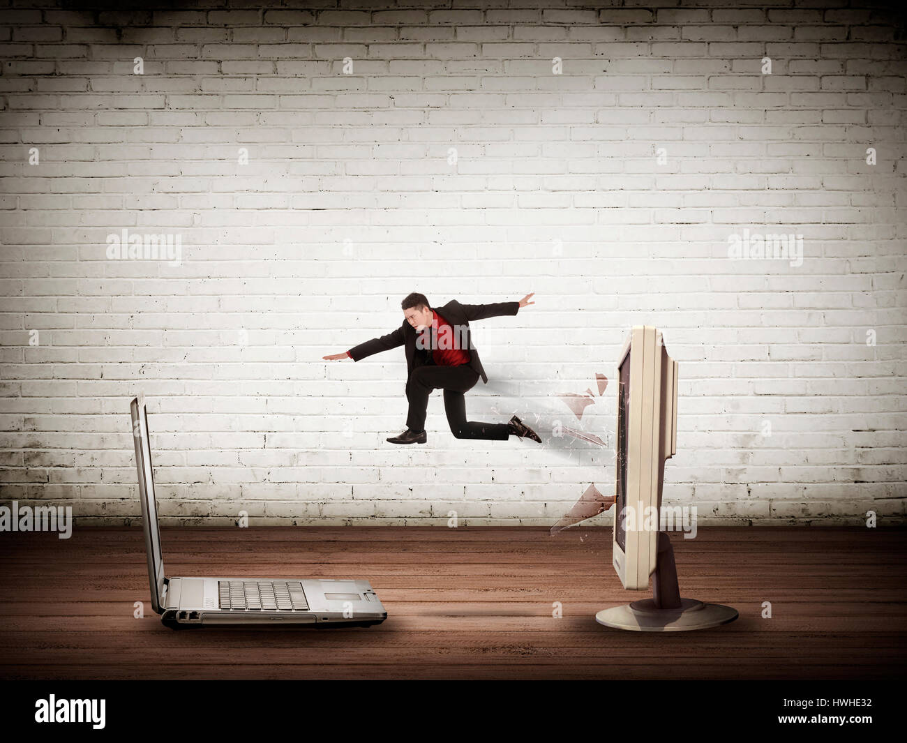 Business man jumping from desktop computer to laptop. Switch to mobile ...