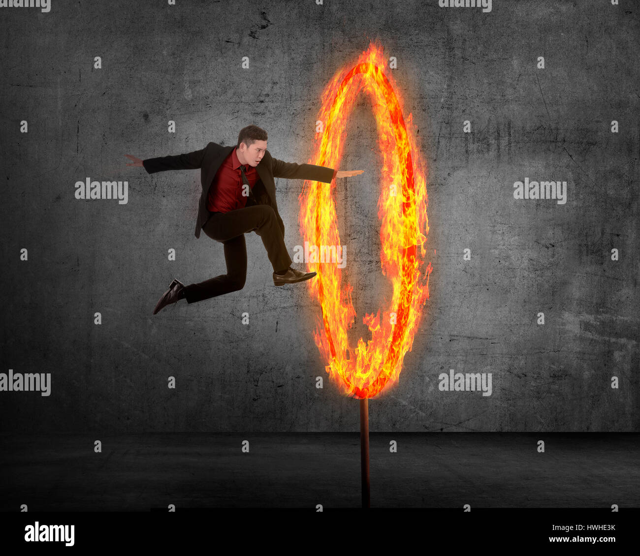 Asian business person jumping through ring of fire. Business risk ...
