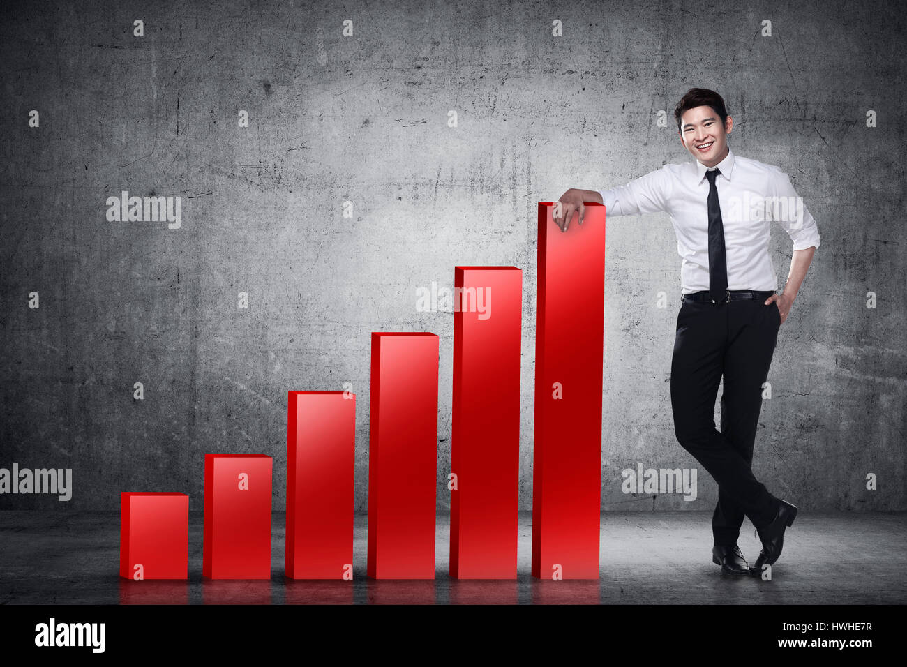 Asian business man leaning to increasing graph Stock Photo - Alamy