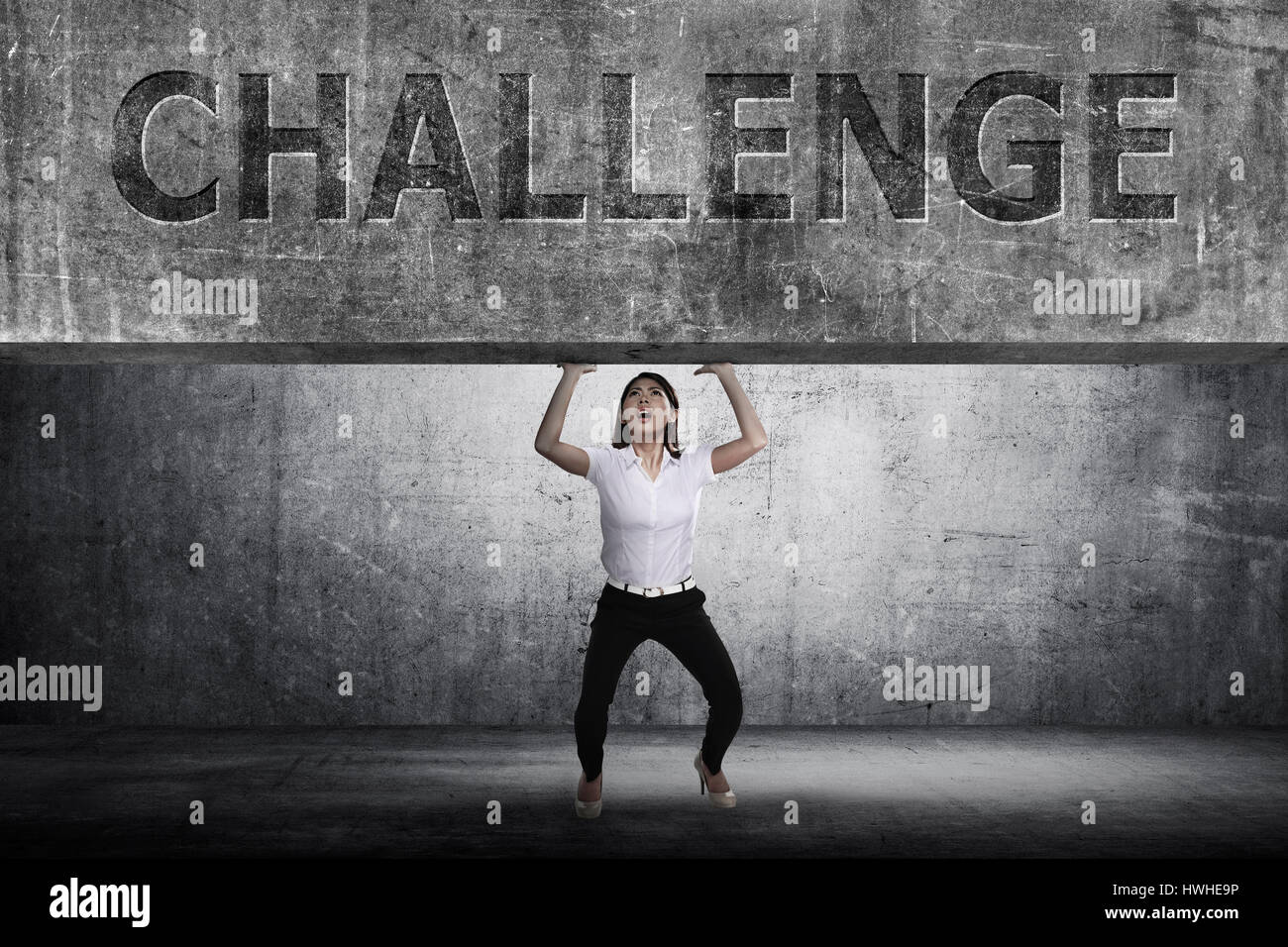 Asian business woman lift heavy block. Business challenge concept Stock ...