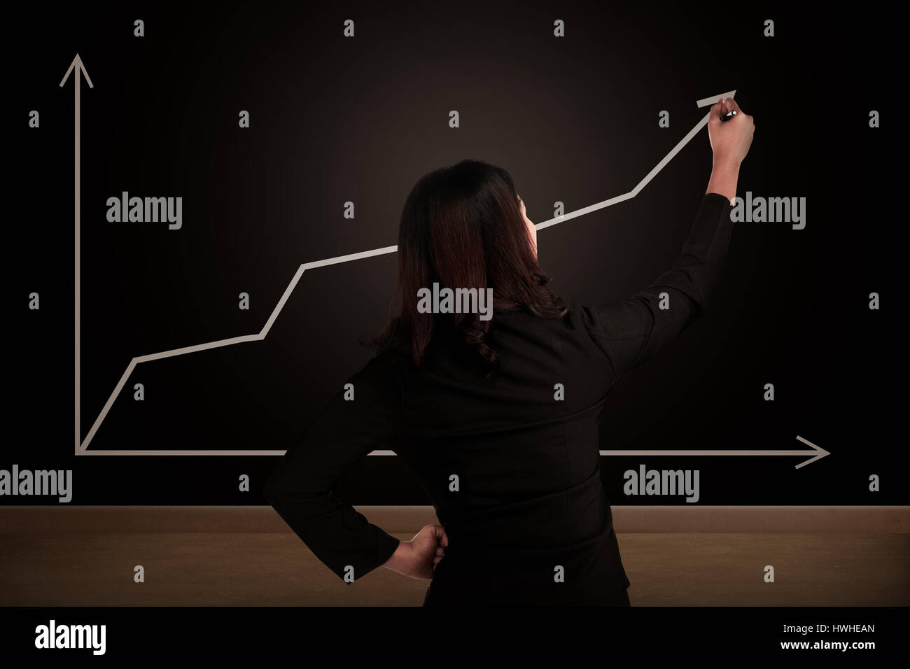 Business woman drawing increasing chart on the chalk board. Business ...