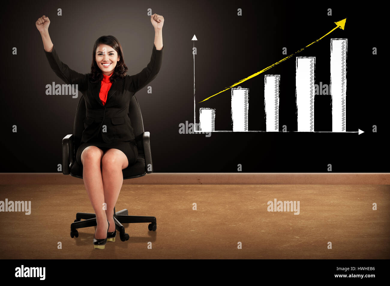 Business person smile over increasing graph drawing on chalk board ...