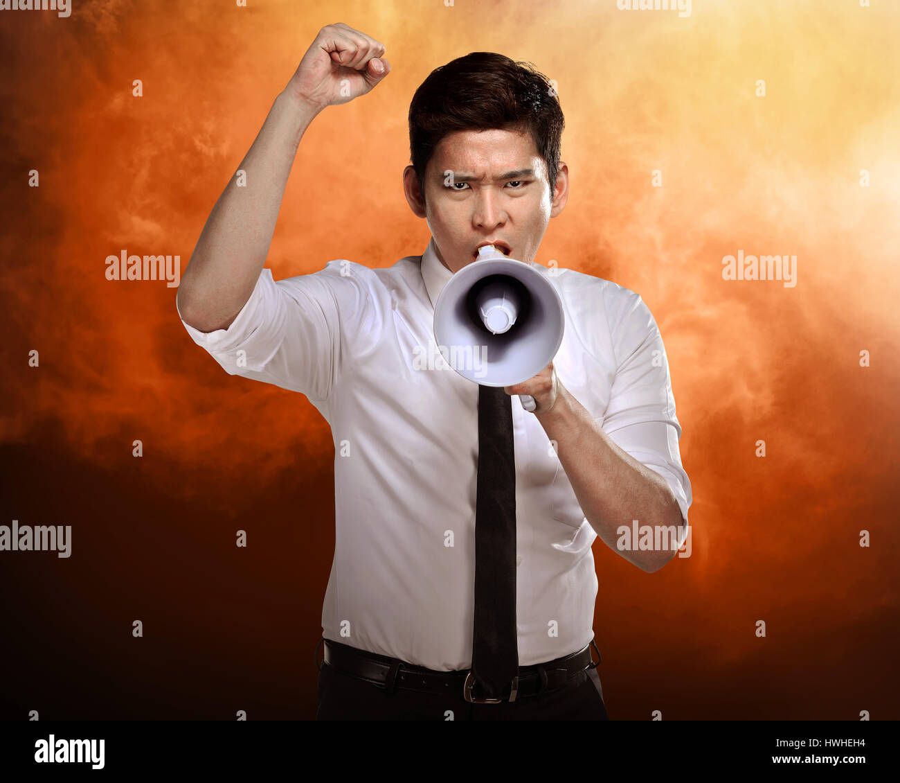 Asian business man talk loud using megaphone Stock Photo - Alamy