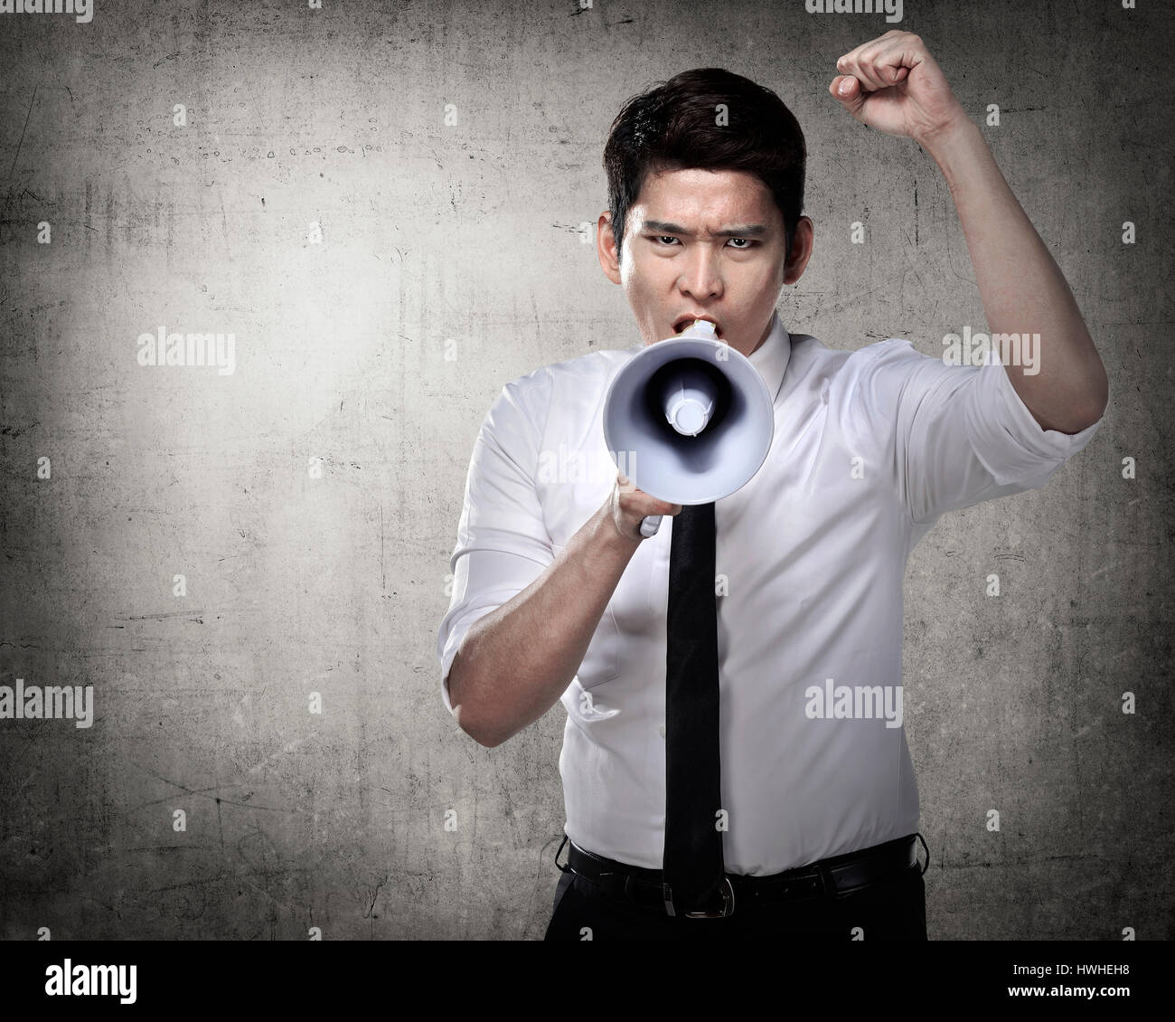 Asian business man talk loud using megaphone Stock Photo - Alamy