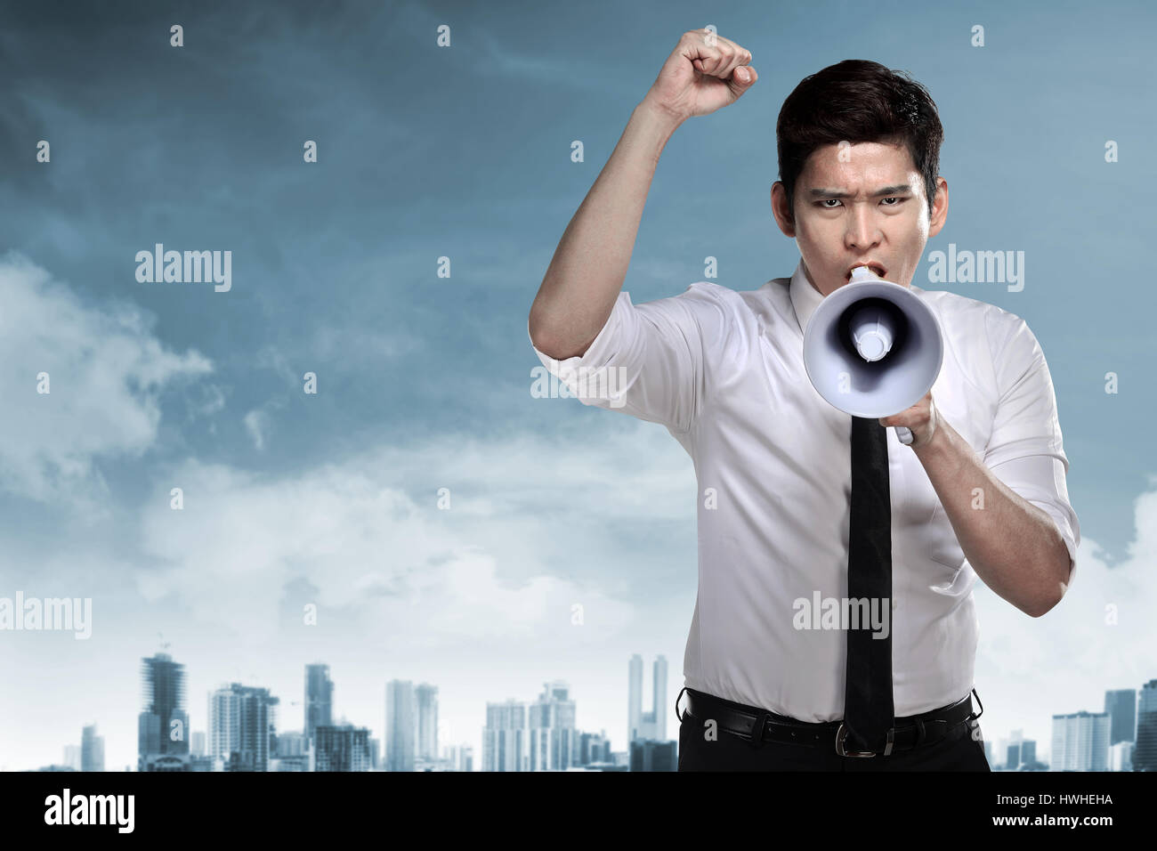 Asian business man talk loud using megaphone Stock Photo - Alamy