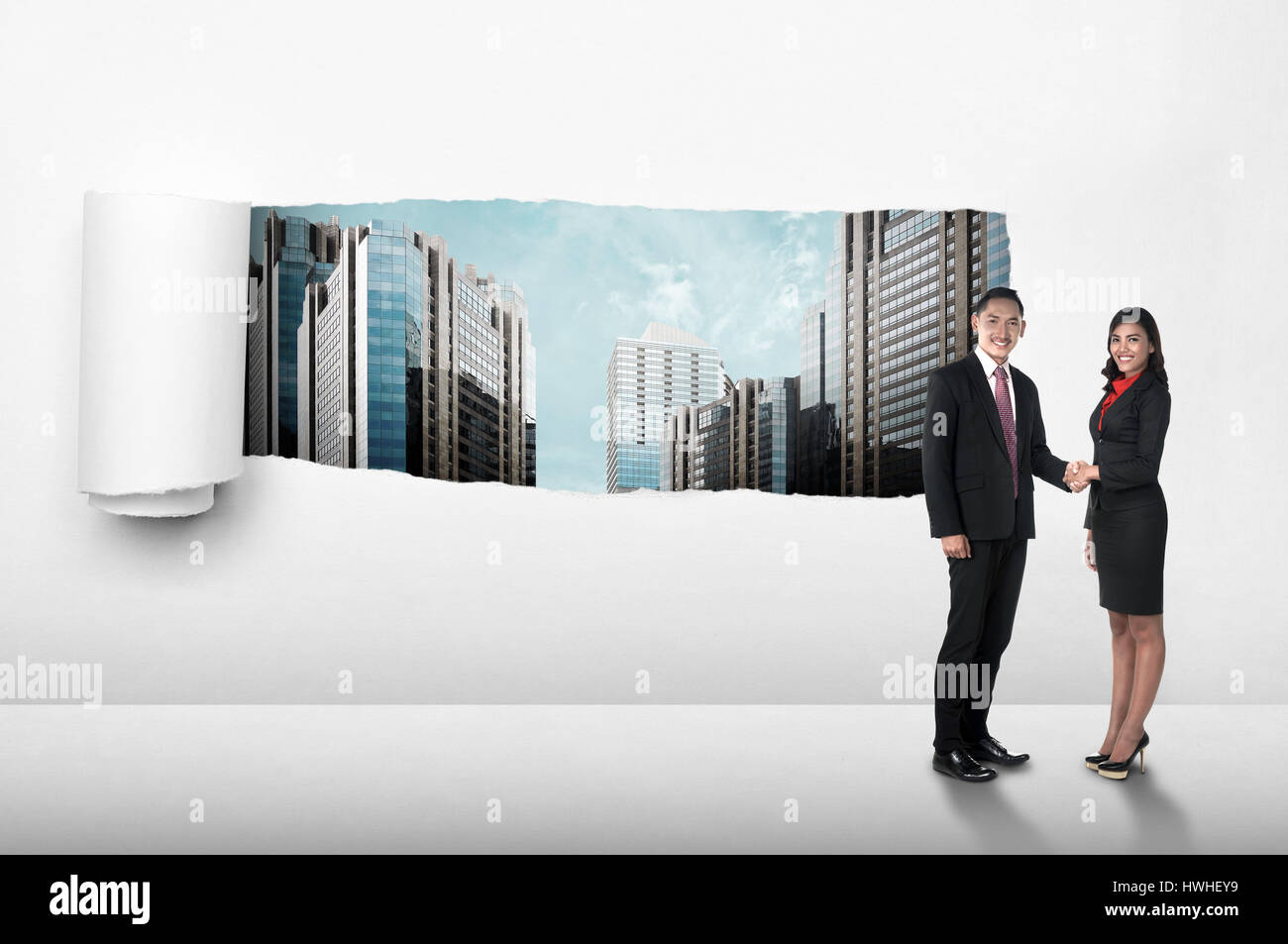 Asian business people shaking hand over paper tear background Stock ...