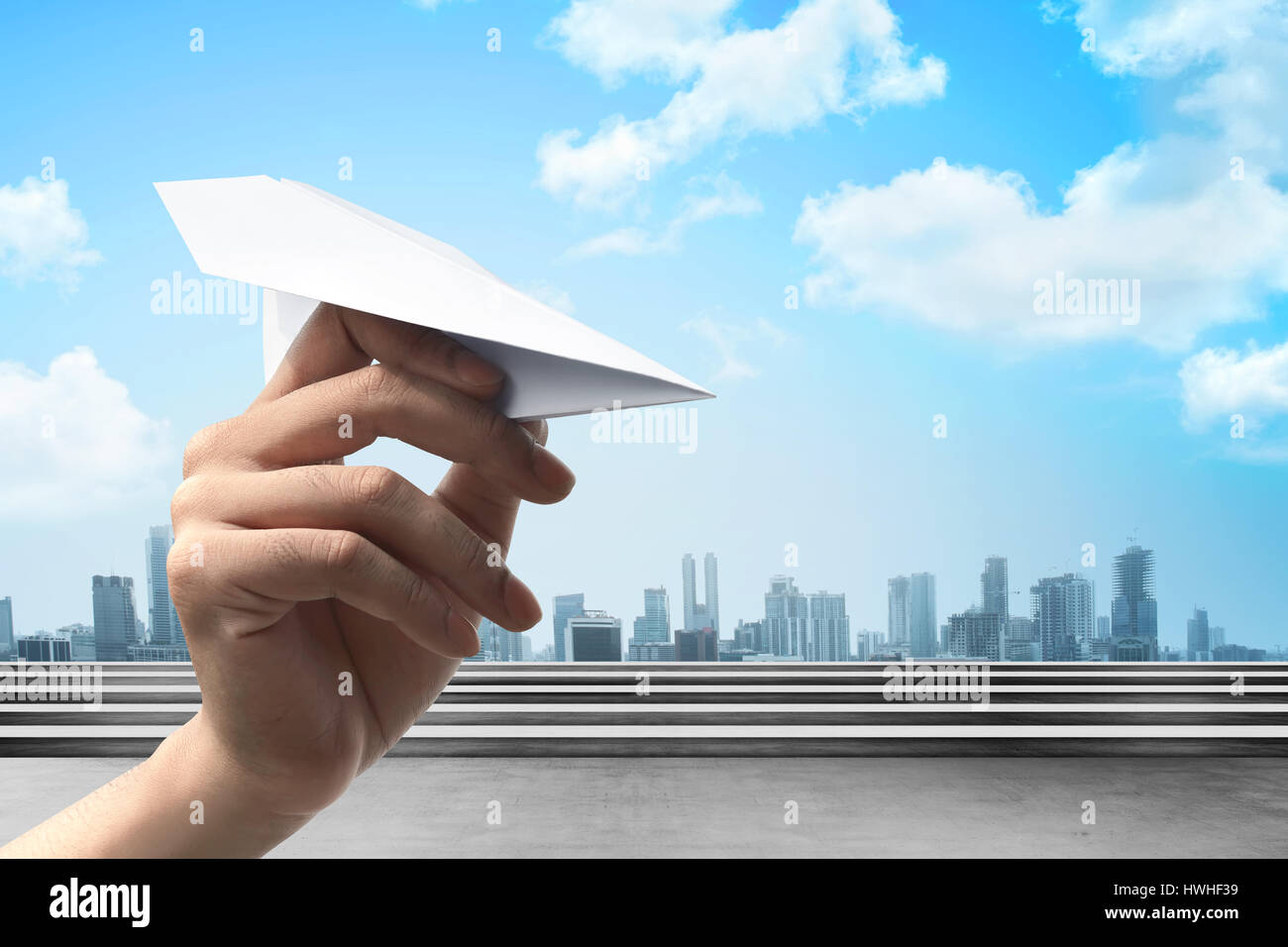 Human hand holding paper plane ready to launch Stock Photo - Alamy