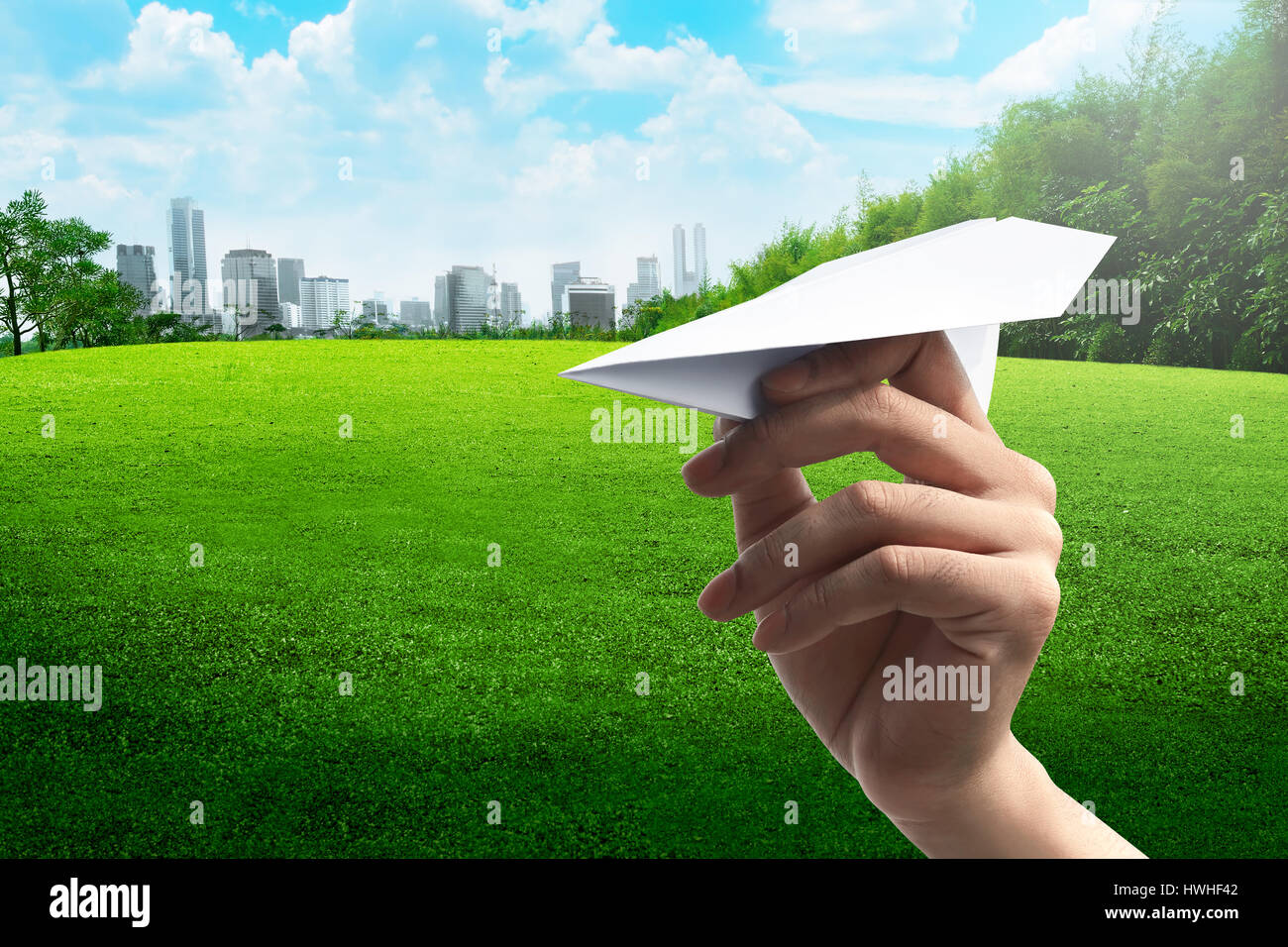 Human hand holding paper plane ready to launch Stock Photo - Alamy