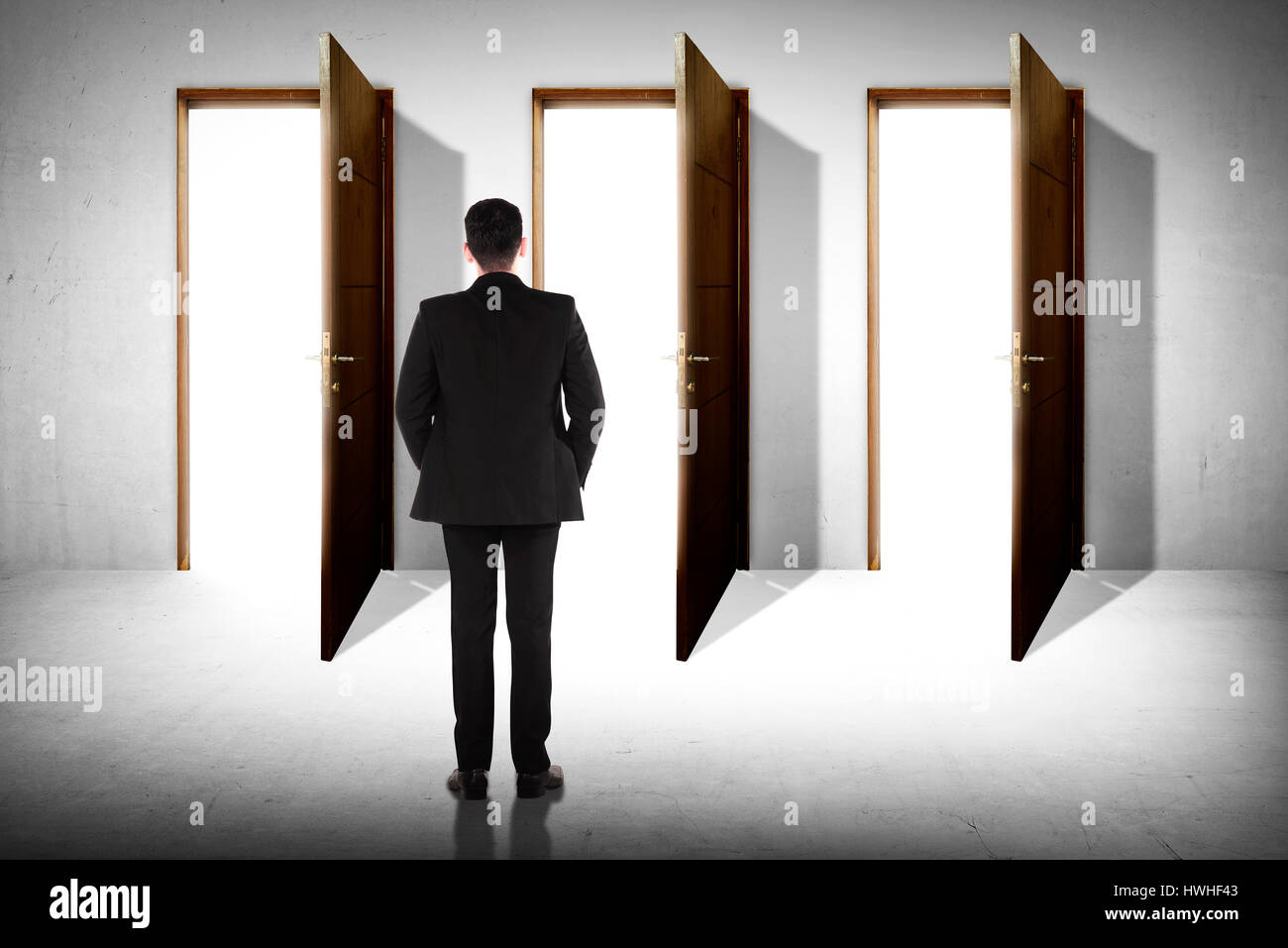 Asian business man has to choose between three options Stock Photo - Alamy