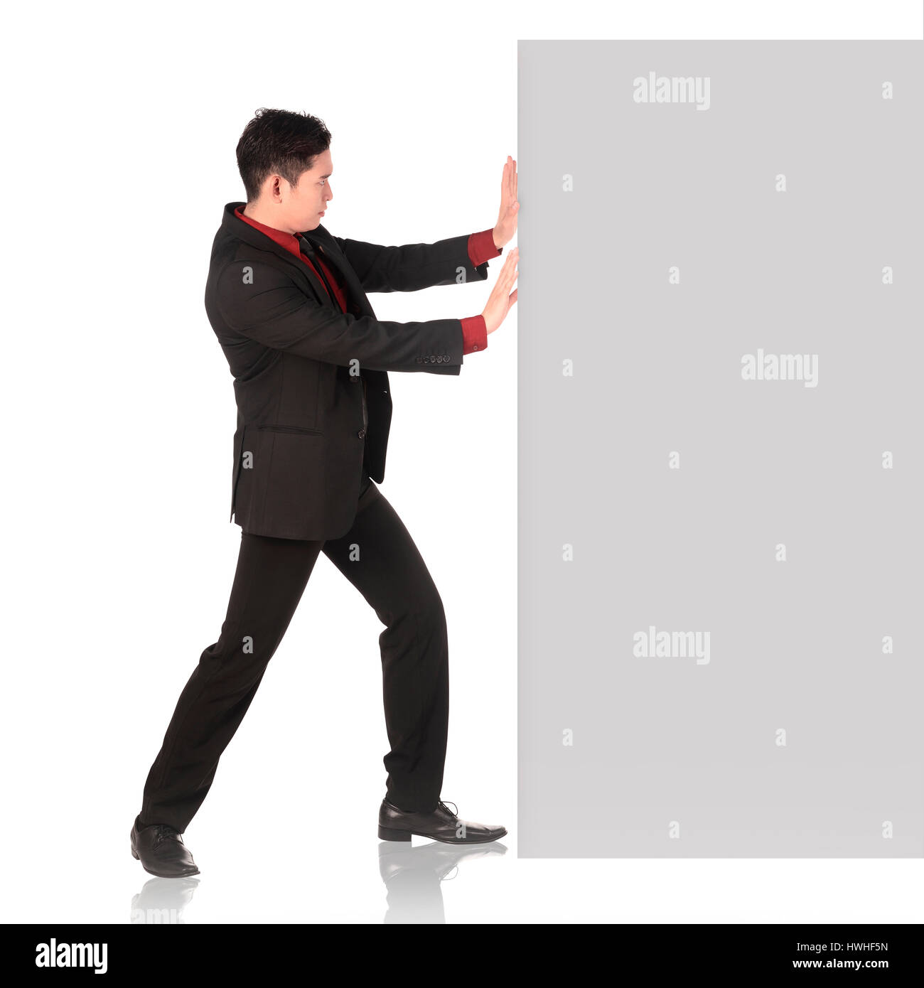Asian business man push something isolated over white background Stock ...
