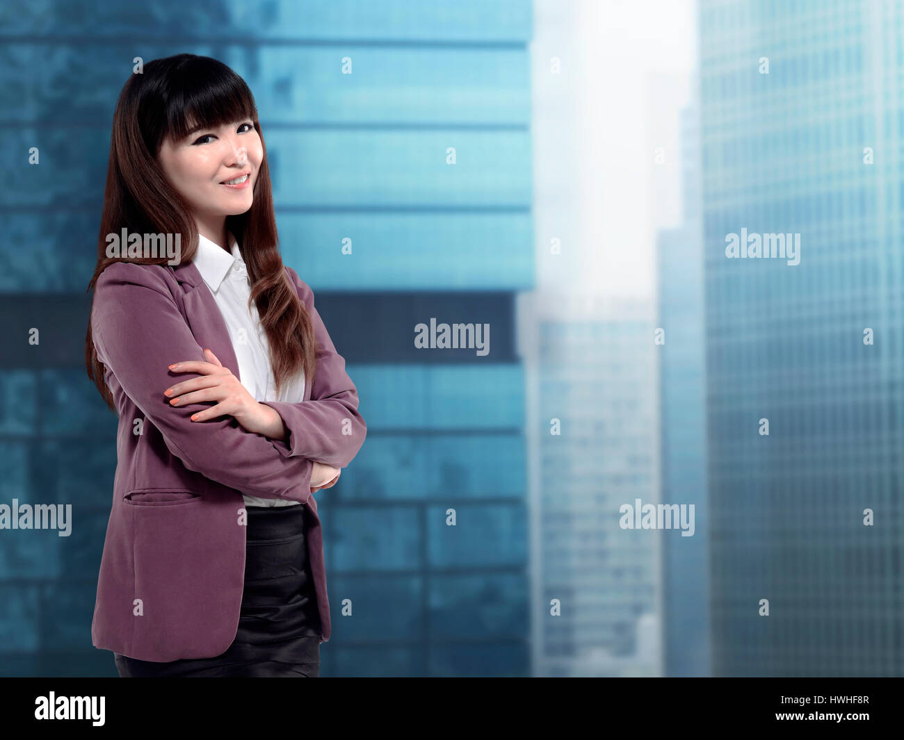 Confident business woman posing over blue building background Stock ...