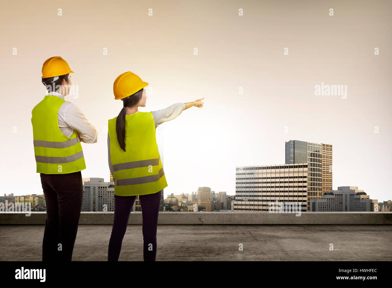 Back view of two architect looking the city from rooftop Stock Photo ...