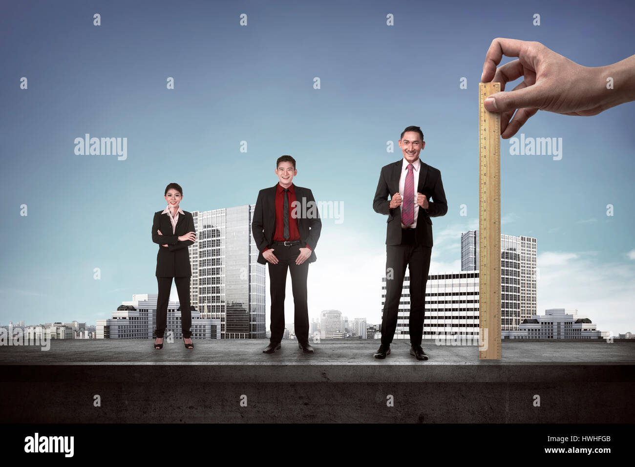 Hand holding wooden ruler, mesuring employee performance. Working ...