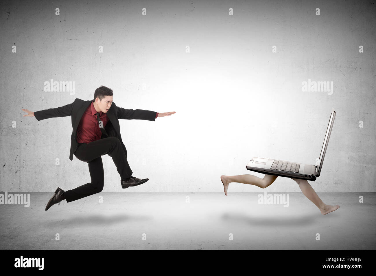 Business man chasing laptop. Chasing your job conceptual Stock Photo ...