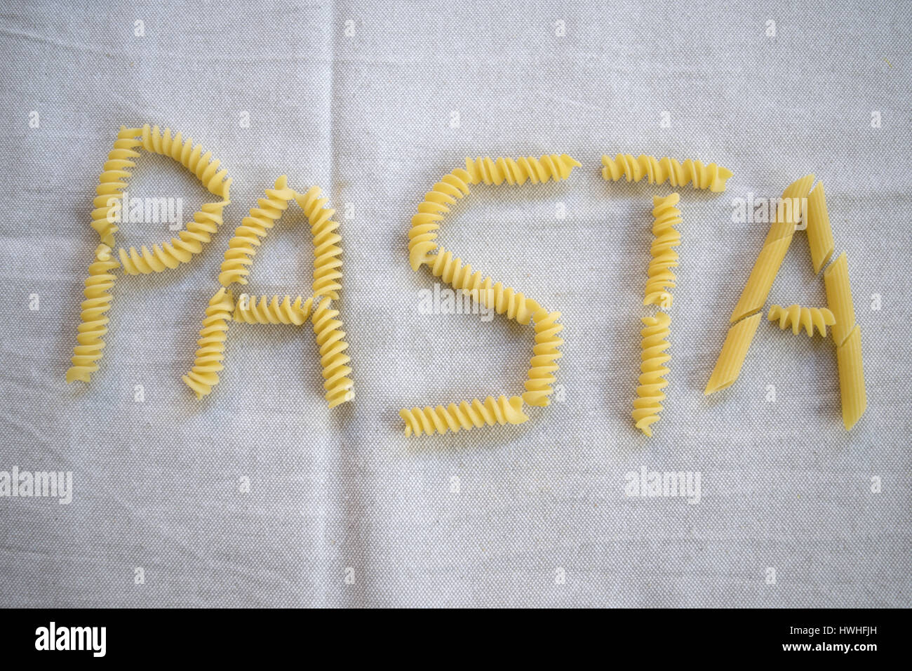 written pasta with raw pasta on white background Stock Photo - Alamy