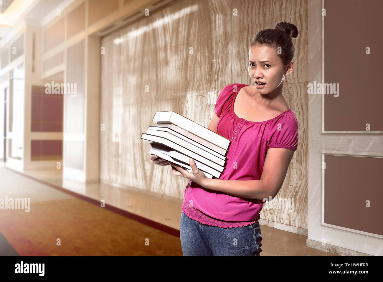 Young student carrying lot hi-res stock photography and images - Alamy